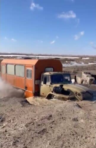 Russian bus driver attempts to cross a river and regrets it