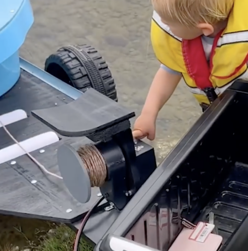 Video shows toddler driving a boat to a lake and sailing it