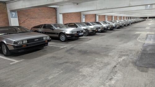 Huge crowd watch fleet of DeLoreans go around test track