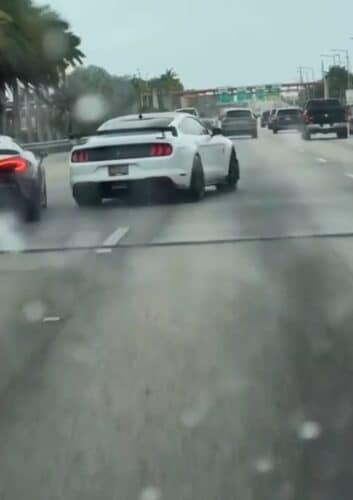 Fishtailing Mustang driver skillfully avoids hitting McLaren