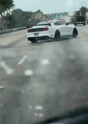 Fishtailing Mustang driver skillfully avoids hitting McLaren