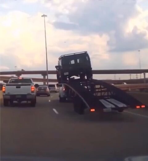 Tow truck flips while carrying a $100,000 Hummer